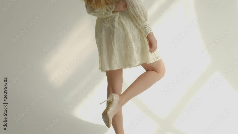 Young girl in high heeled shoes poses for the photographer. model works ...
