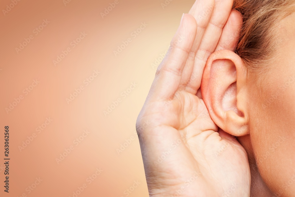 Girl listening with her hand on an Stock Photo | Adobe Stock