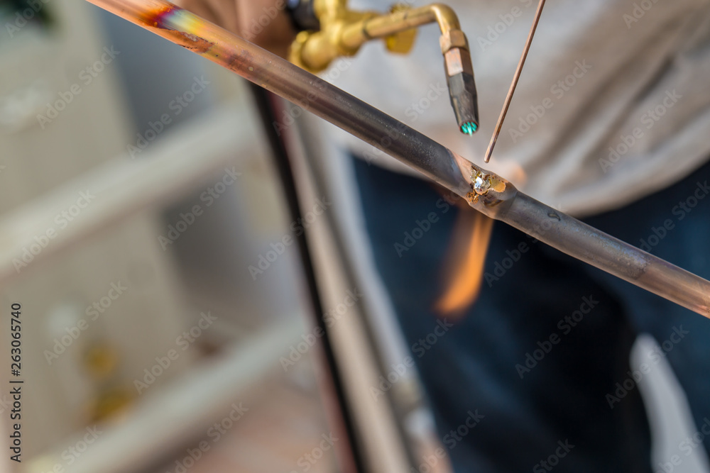 Welding of copper pipe of a methane gas pipeline or of a conditioning ...