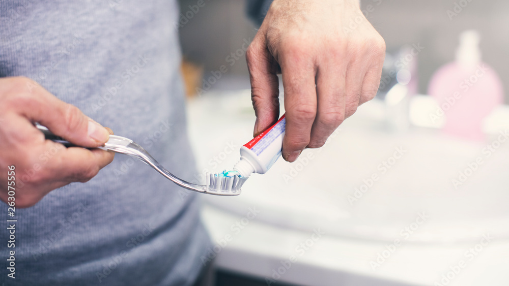 Hand extrude a toothpaste from a tube on a toothbrush Stock Photo ...