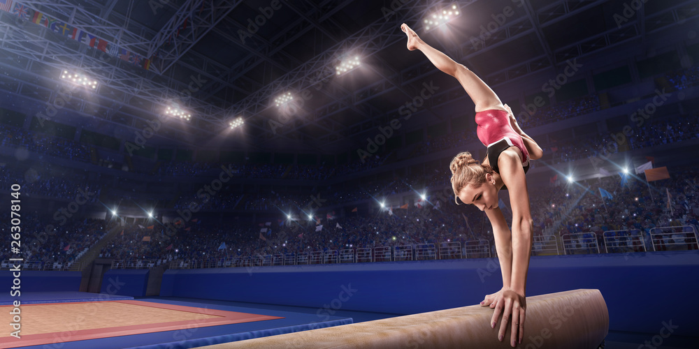 Female athlete doing a complicated exciting trick on gymnastics balance ...