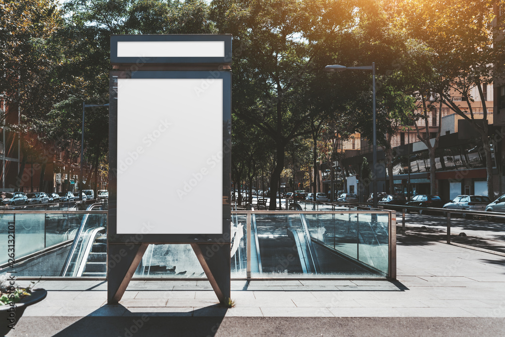 Mockup of an outdoor advert blank vertical poster near an underground ...