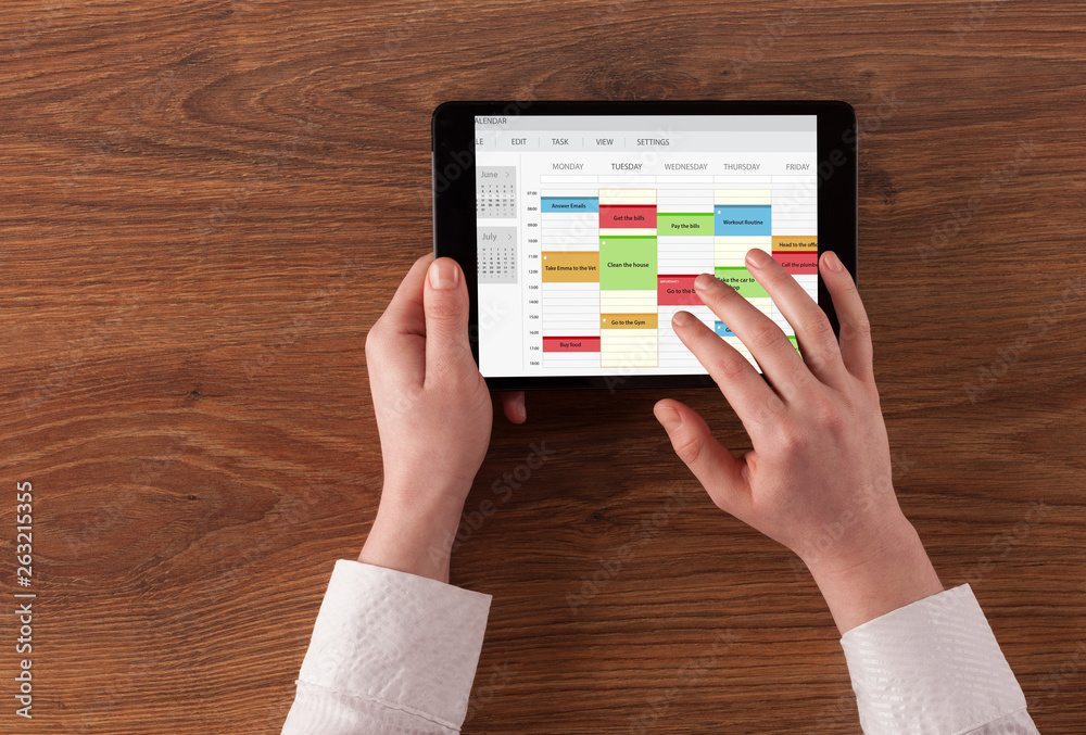 Hand holding tablet with timetable and calendar concept Stock Photo ...