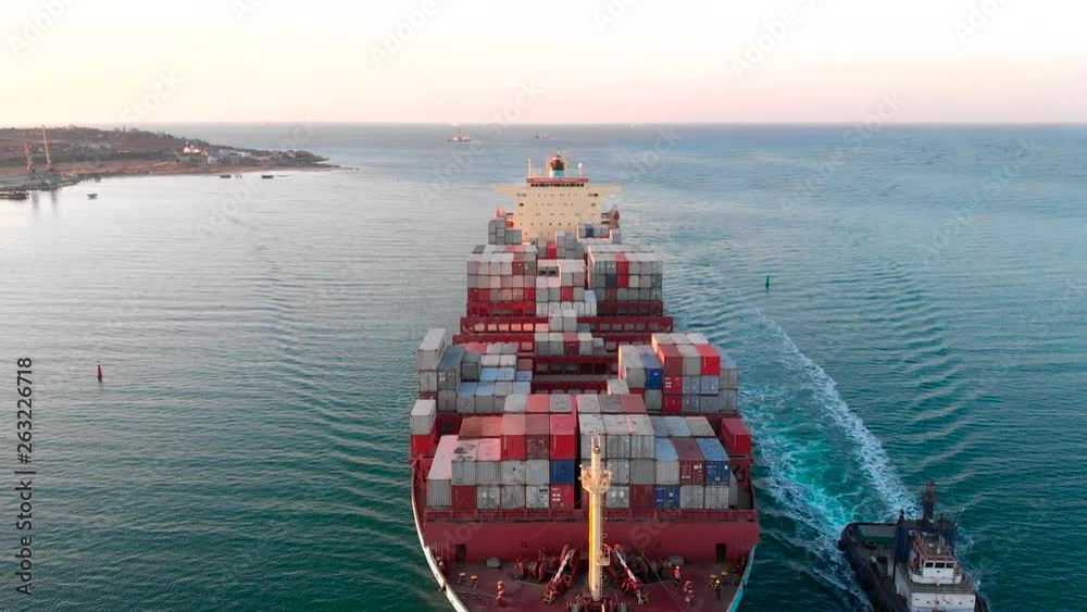 Large modern container ship moves along the route and arrives at the ...