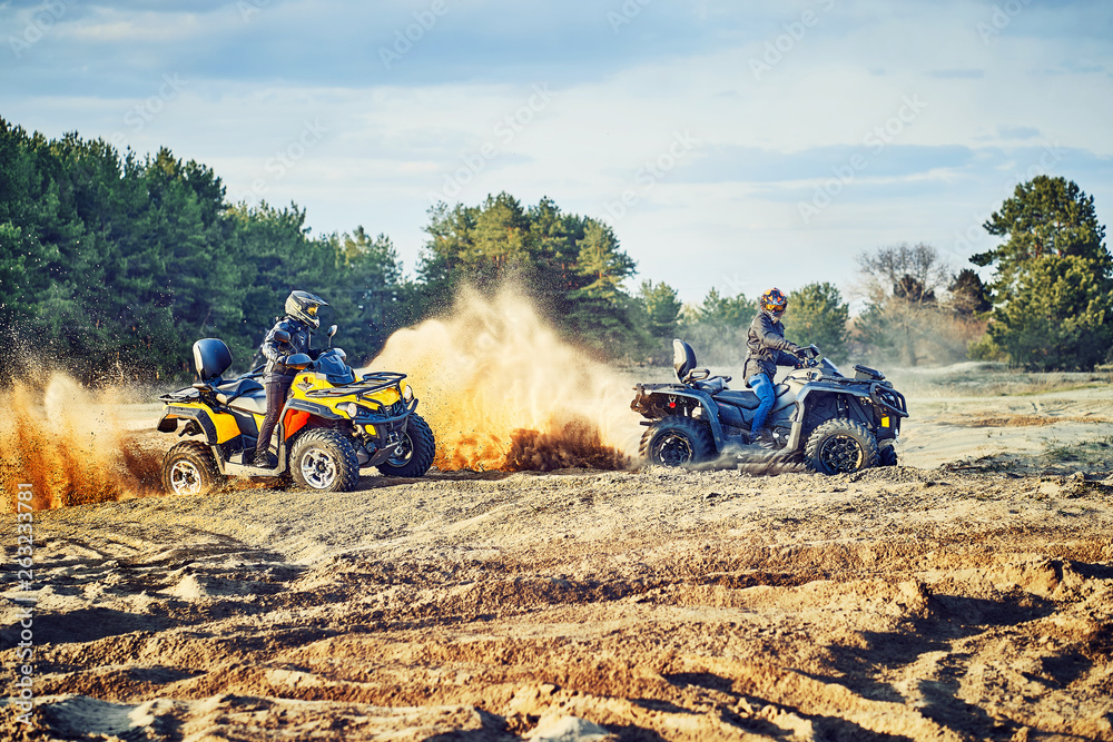 Teen riding ATV in sand dunes making a turn in the sand Stock Photo ...