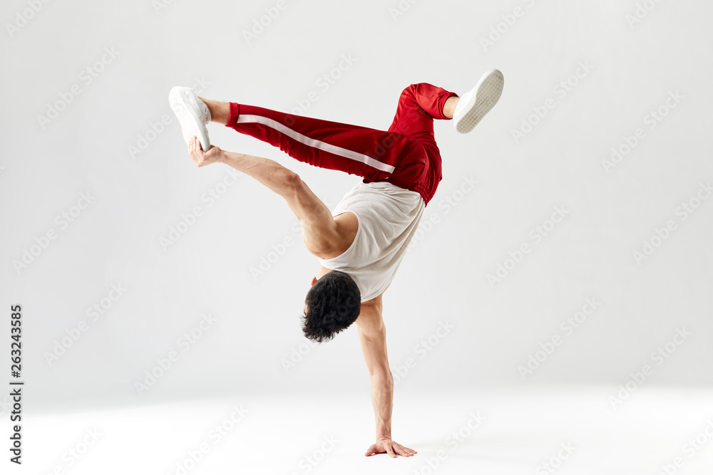 Isolated Korean hip hop male break dancer dancing on white background ...