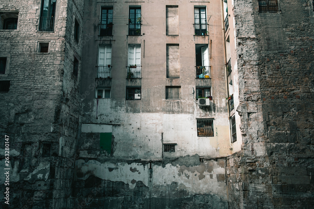 tall old apartment complex building showing signs of aging with brick ...