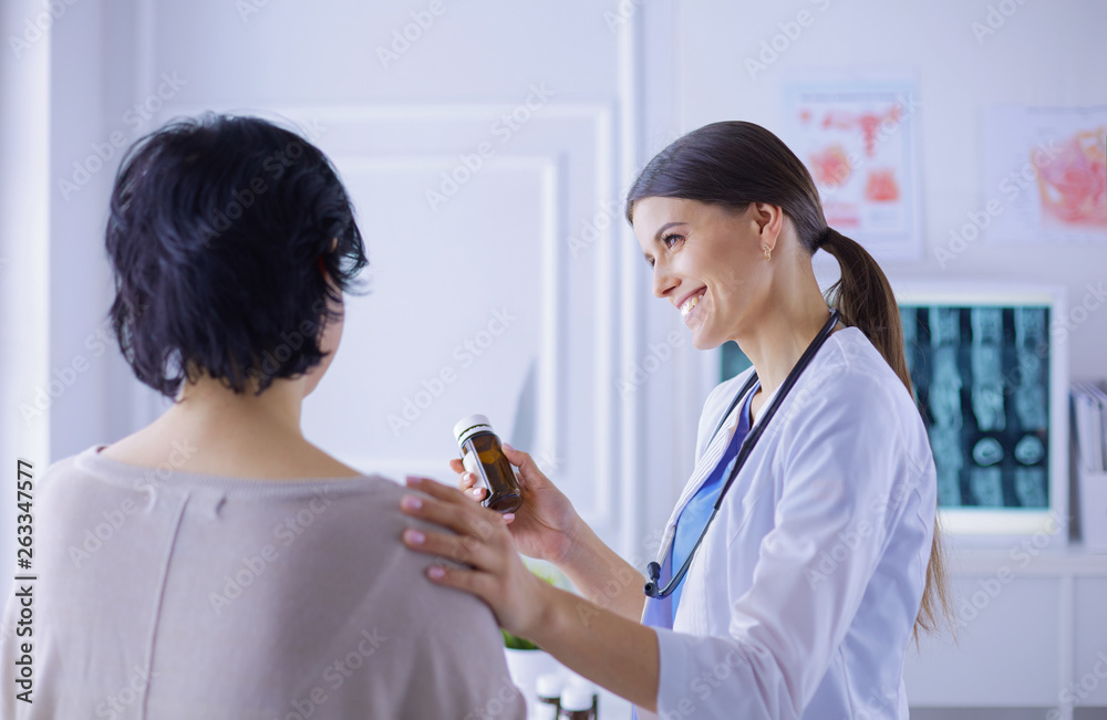 Beautiful female doctor explaining medical treatment to a patient ...