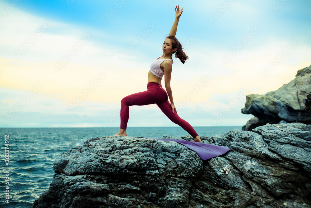 Side view of woman doing exercise yoga. standing in warrior I and ...