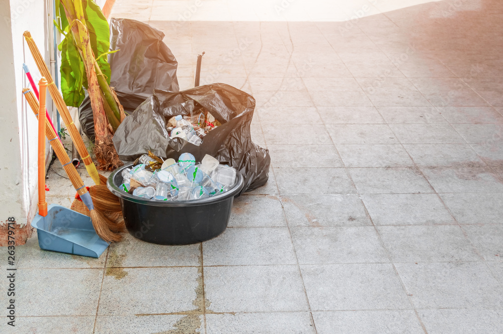 plastic trash bag. Pile black garbage On floor Beside the building wall ...