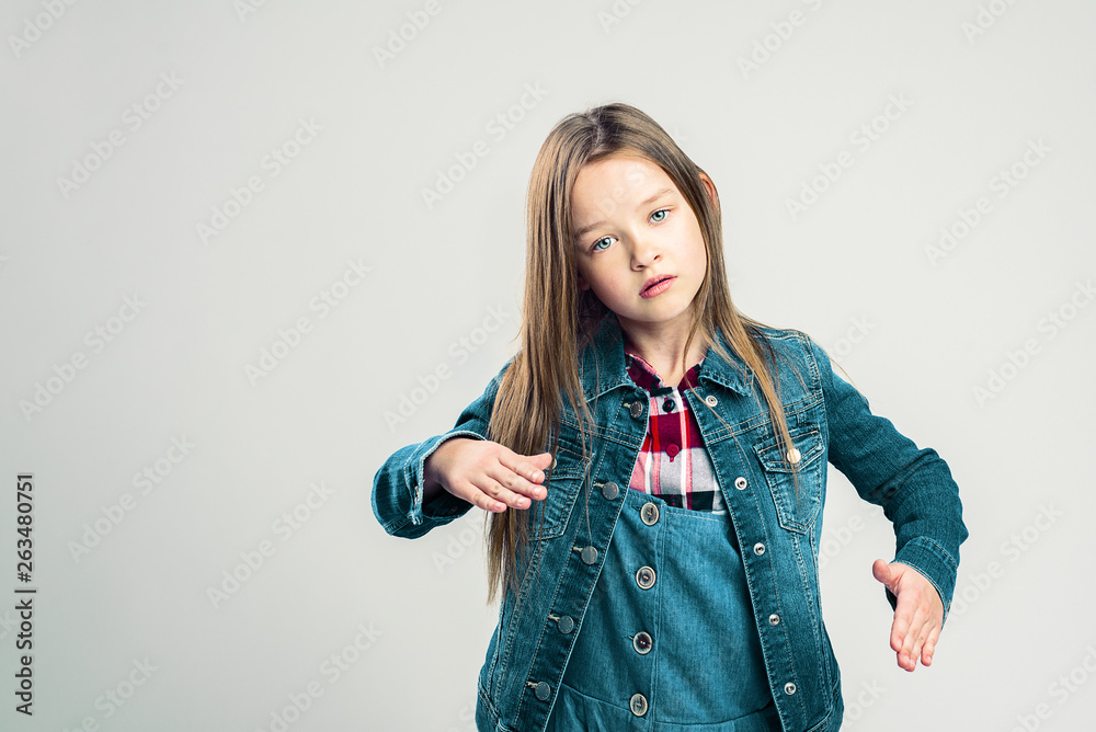 little girl depicts a robot. child poses in the studio and makes ...