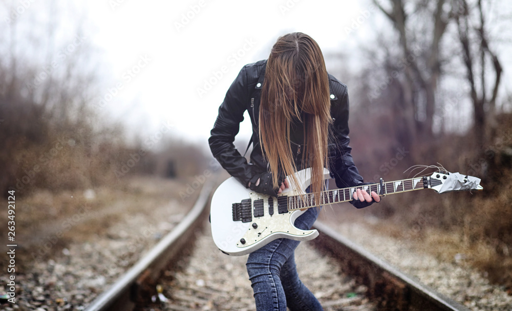 Beautiful young girl rocker with electric guitar. A rock musician girl ...