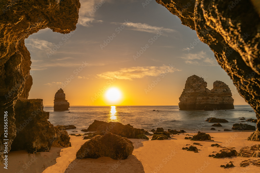 Beautiful beach photographed from a cave at sunrise Stock Photo | Adobe ...