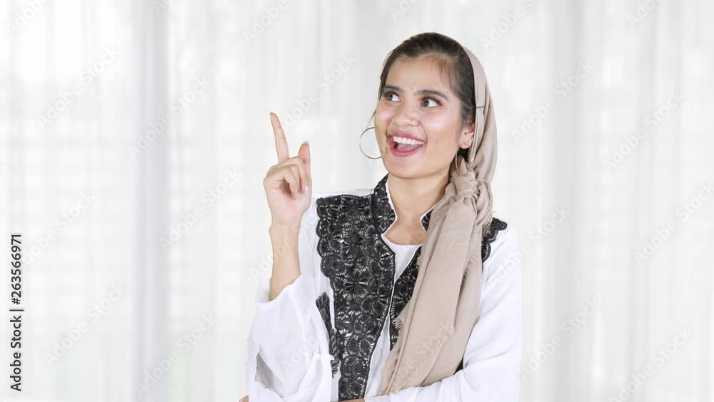 Thoughtful young muslim woman thinking idea while standing and wearing ...