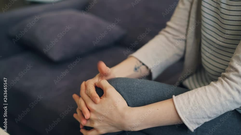 Close-up of young woman moving hands expressing anxiety and nervous ...