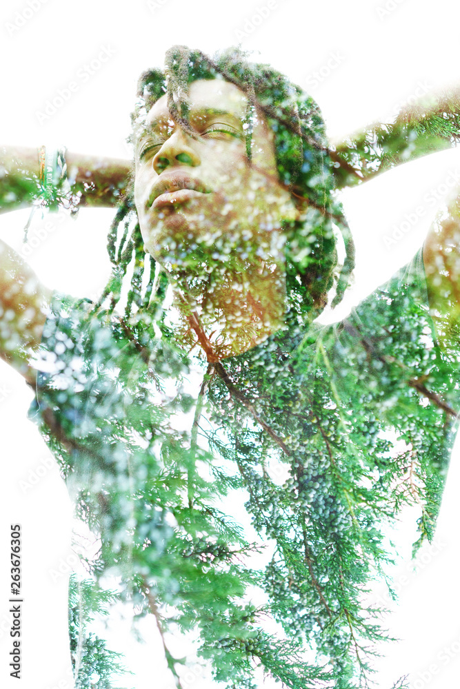 Double exposure of a dark skinned man with dreadlocks and hands behind ...