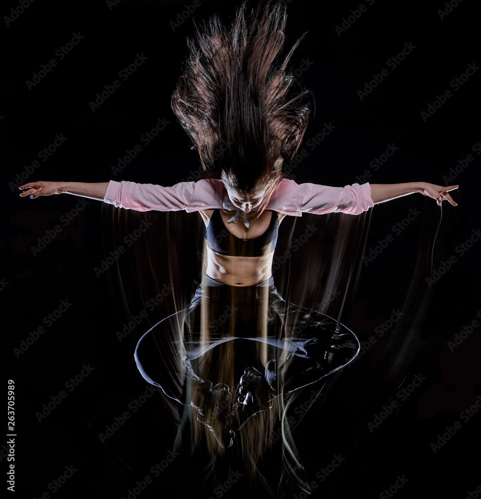 one caucasian young woman modern dancer dancing isolated on black ...