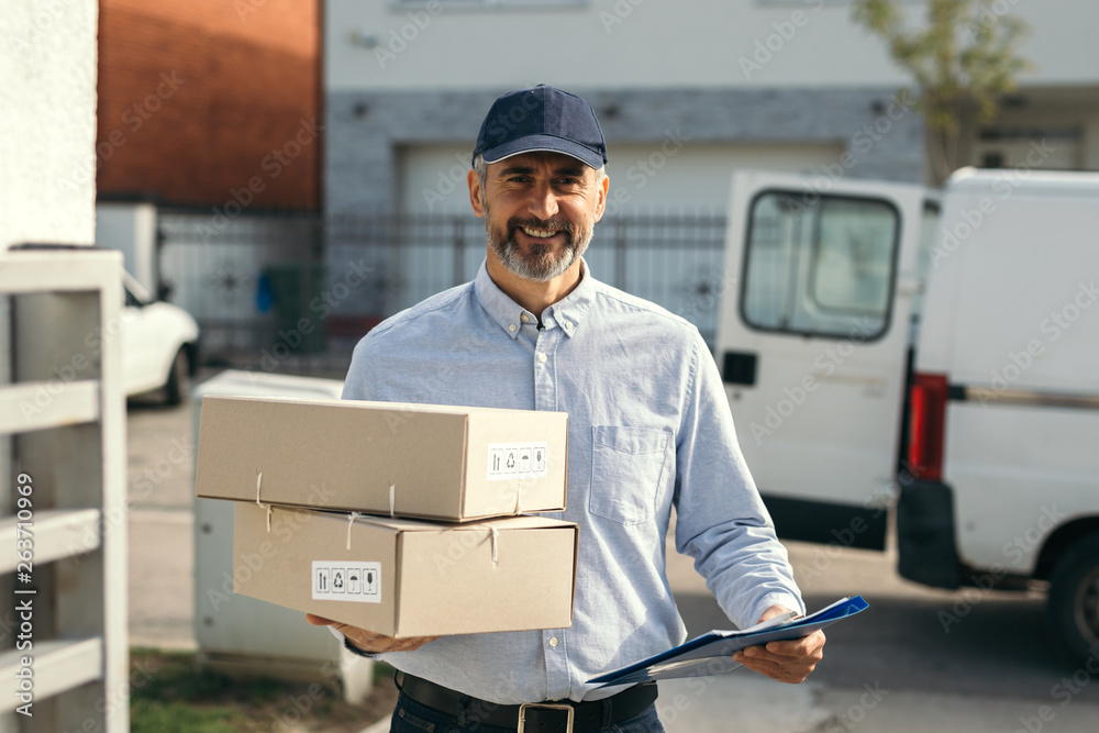 delivery man holding parcel boxes Stock Photo | Adobe Stock