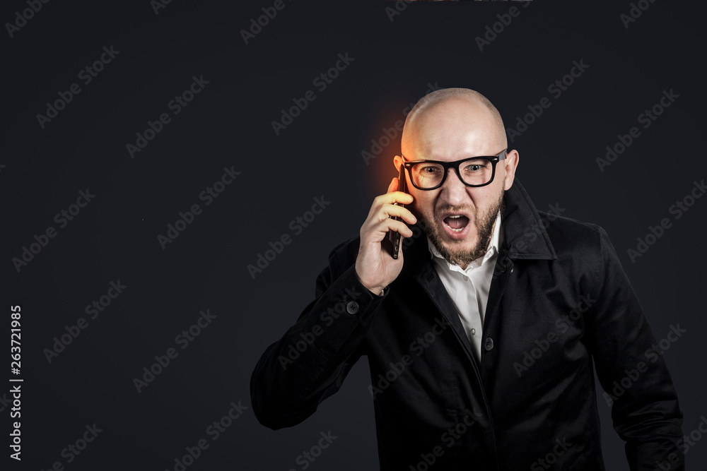 Male businessman with an evil face in a white shirt and dark cloak ...