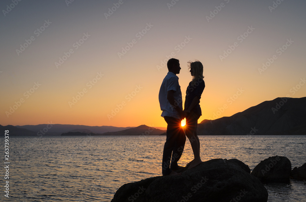 Romantic couple on sunset background Stock Photo | Adobe Stock