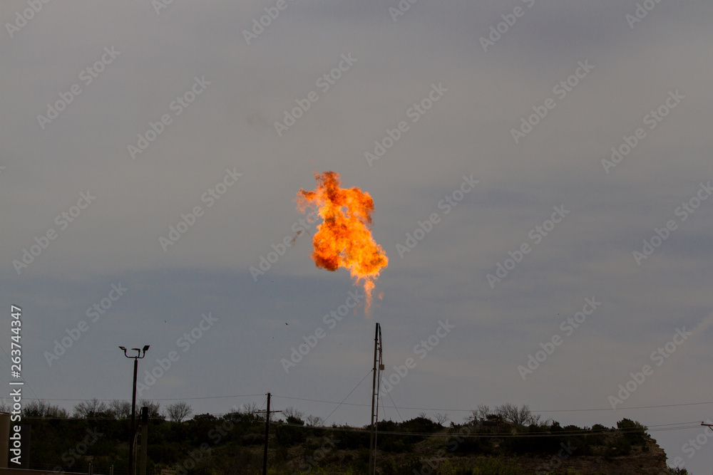Gas plume or flare releases methane, a dangerous greenhouse gas, into ...