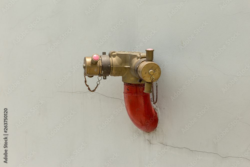 Red fire pump in front of concrete wall. fire safety pump on cement ...