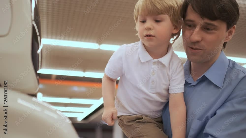 Robot and child. Boy looking for dancing robot. Kid boy watching robot ...