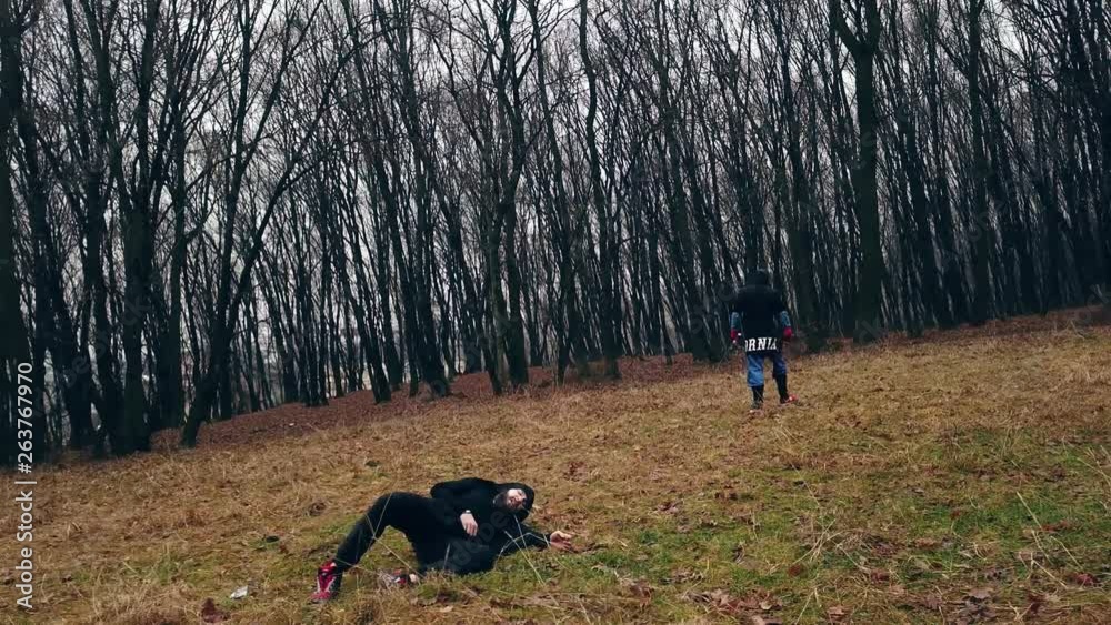 Characters do battle in a forest clearing. Camera intentionally tilted ...