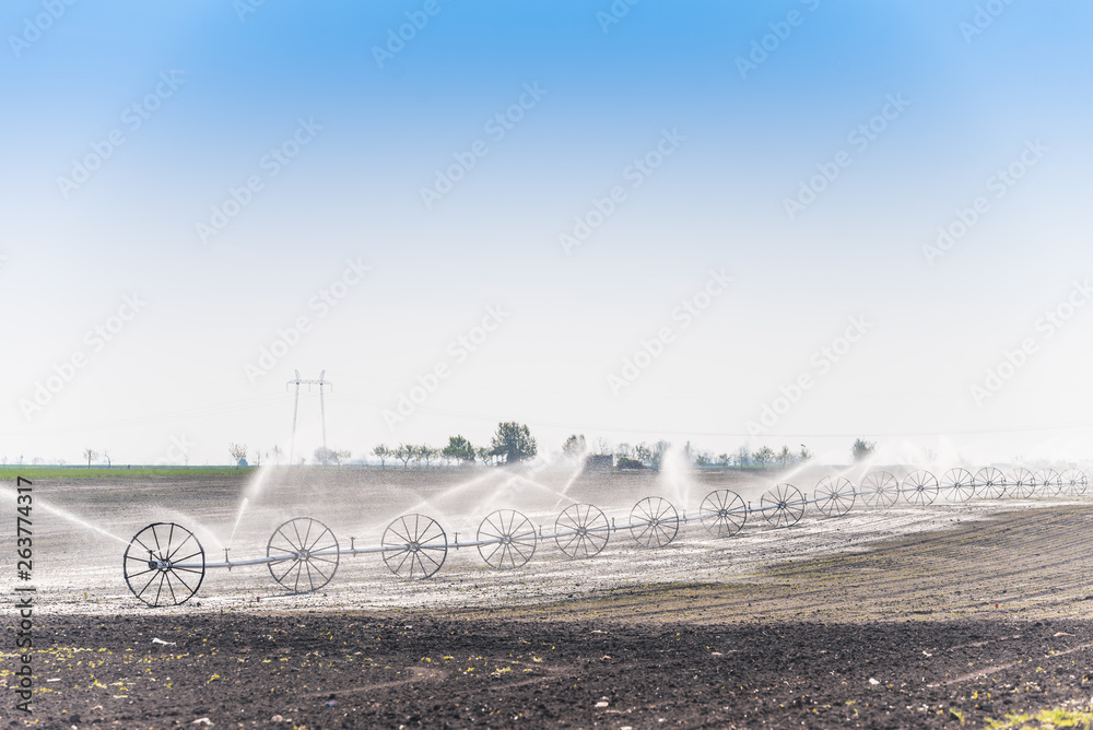 large wheels with sprinklers for irrigation in the field Stock Photo ...