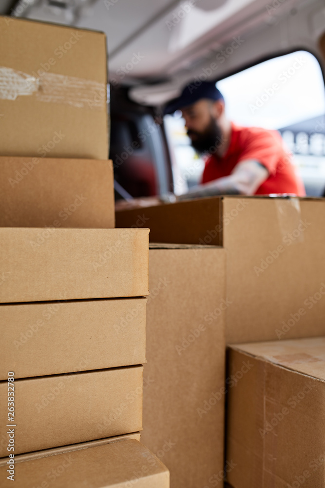 Delivery man loading the car with boxes. Stock Photo | Adobe Stock