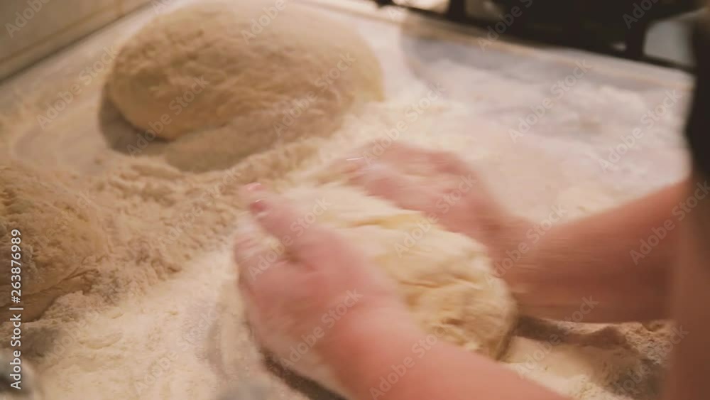 The hostess knead dough for bread. Close up slow motion RAW footage of ...