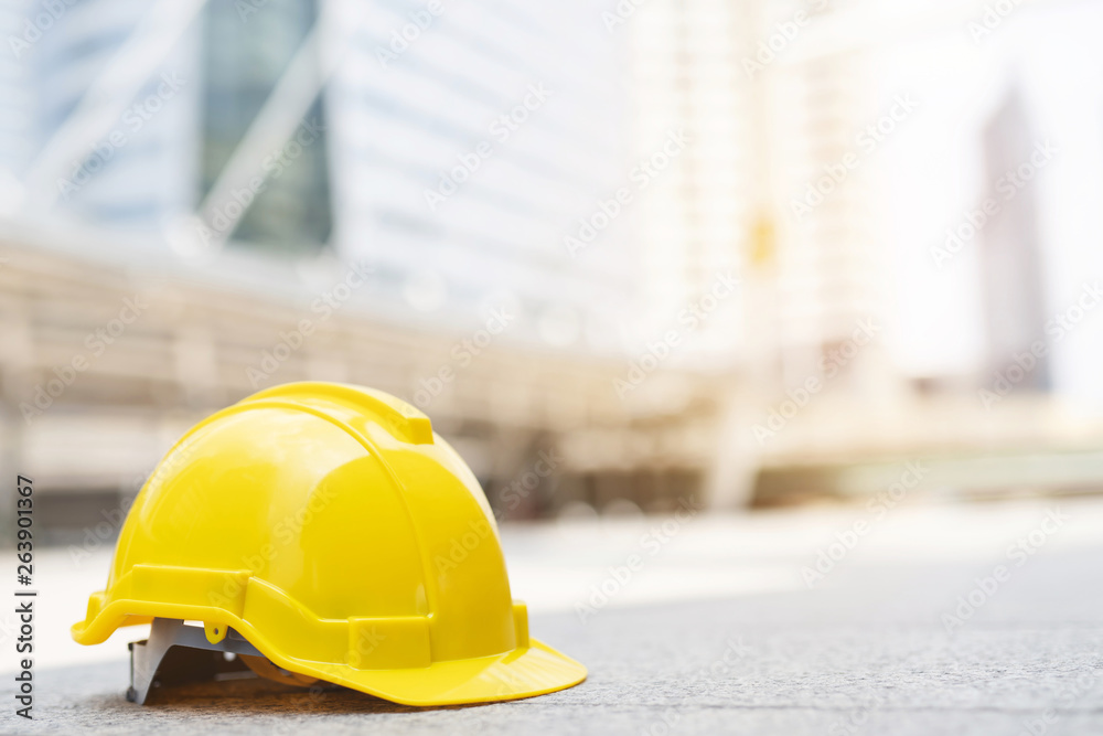 yellow hard safety wear helmet hat in the project at construction site ...