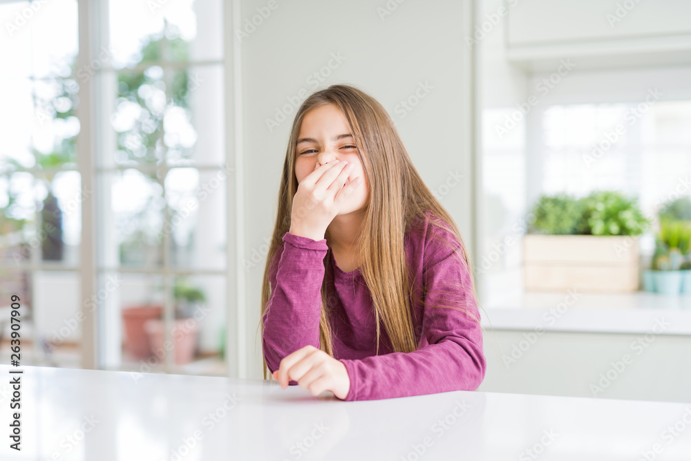 Beautiful young girl kid on white table smelling something stinky and ...