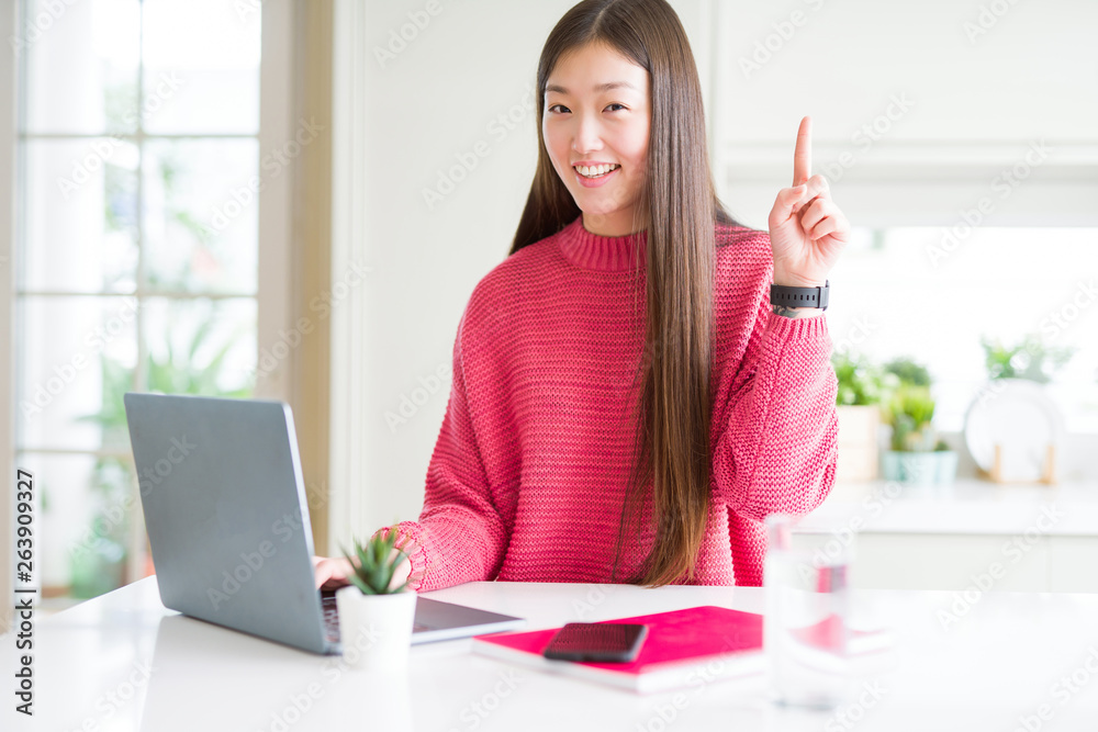 Beautiful Asian woman working using computer laptop surprised with an ...