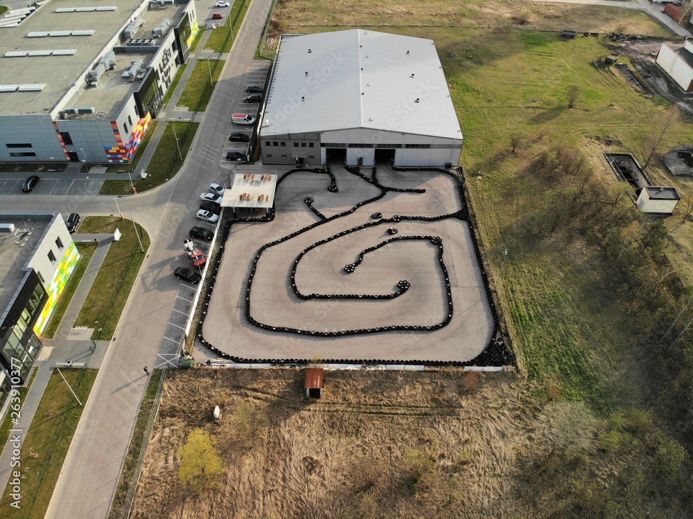 Aerial image of outdoor go kart racetrack made of tyres. People driving ...