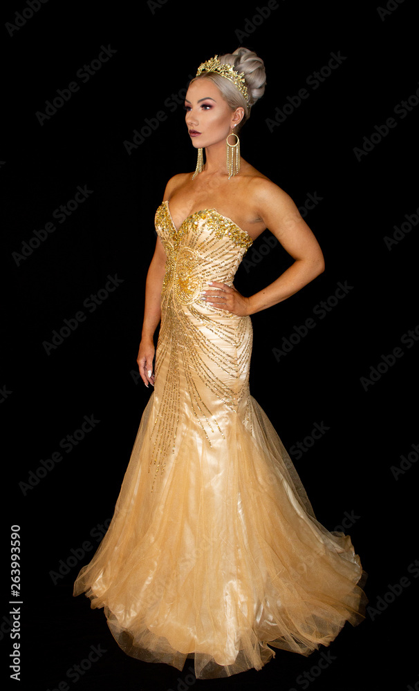 Beautiful golden queen posing on black background Stock Photo | Adobe Stock