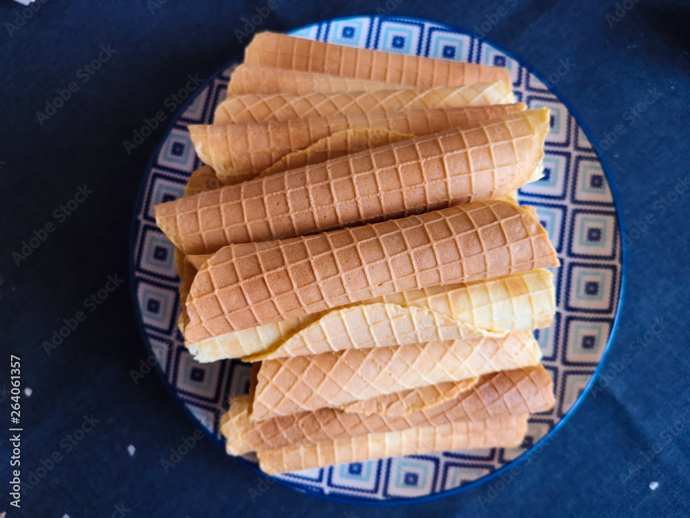 Wafer rolls, golden color. Many wafer rolls group. Edible tubules ...