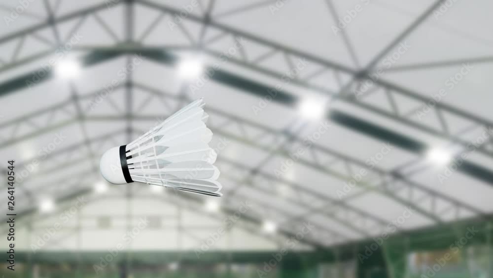 Shuttlecock in rotation passing right to left in slow motion inside a ...