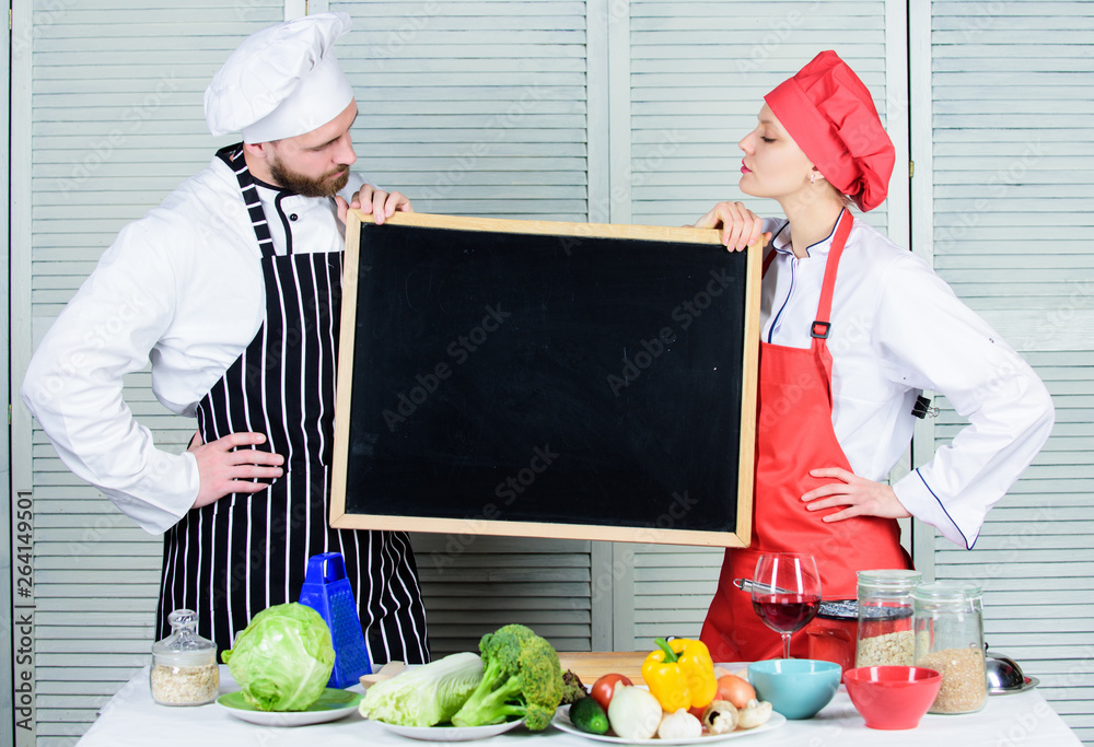 Teaching different cooking techniques. Couple of man and woman holding ...