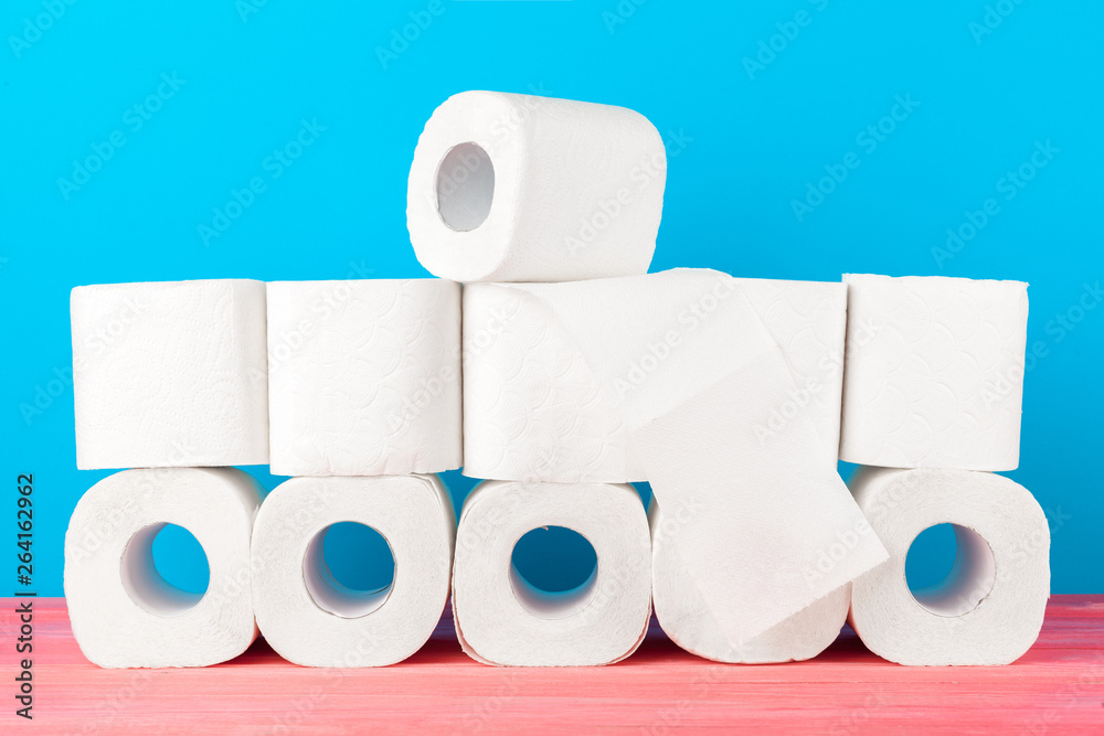 Toilet paper stack on bright blue background Stock Photo | Adobe Stock