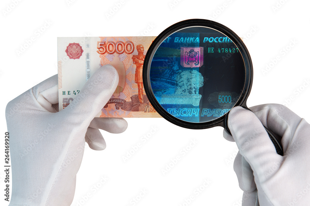 Investigeting counterfeit money. Hands in white gloves with x ray ...