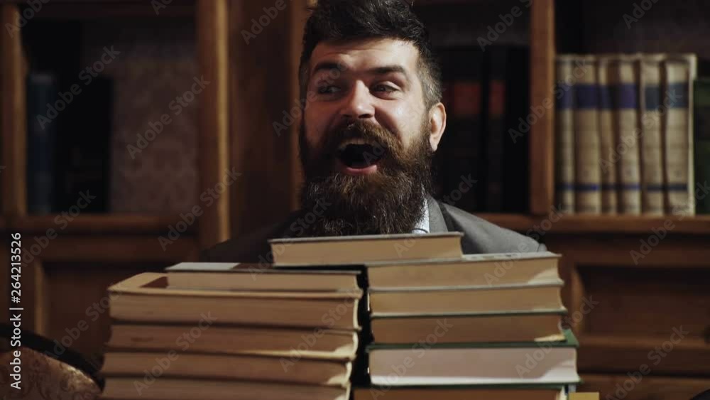 Video Stock Man, nerd on surprised face between piles of books in ...