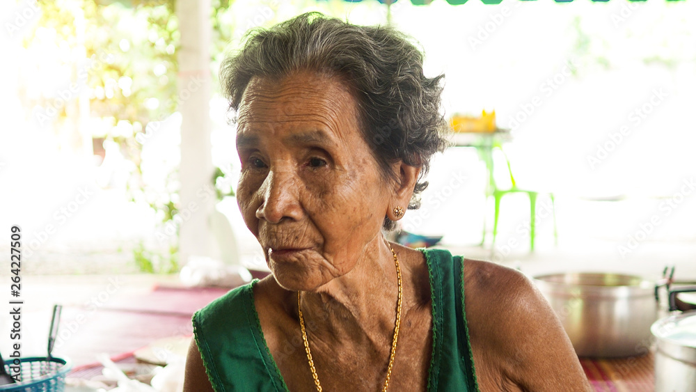 Asian women, aging skin, wrinkled skin wearing a green sleeveless shirt ...