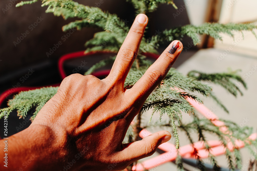 Man showing peace sign with his hand and showing off the ink mark on ...