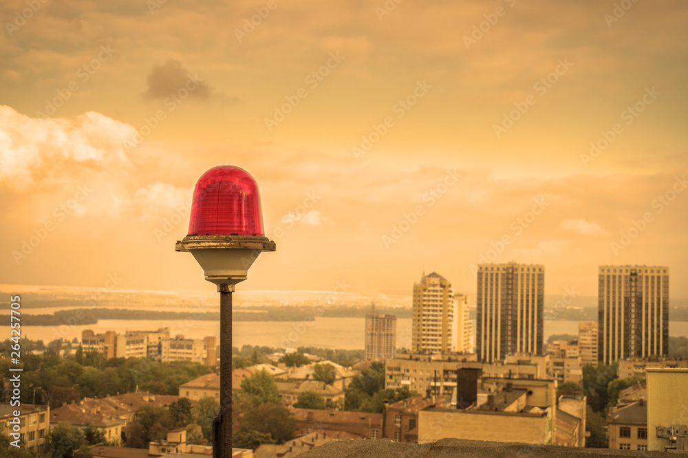 A red alarm is on the roof of a tall building. Obstruction Lights on ...