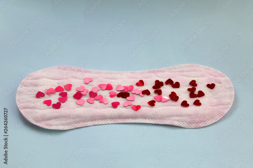Period pad with red heart shaped sequins symbolizing menstruation. Top ...