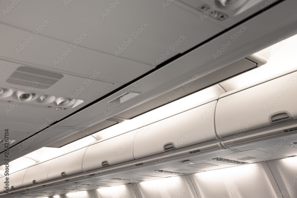 Poster Overhead compartment row of an airplane cabin interior. – Wall ...