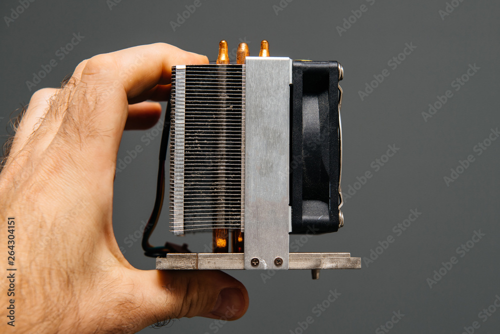 Man holding dusty dirty computer CPU heatsink cooler of a server ...