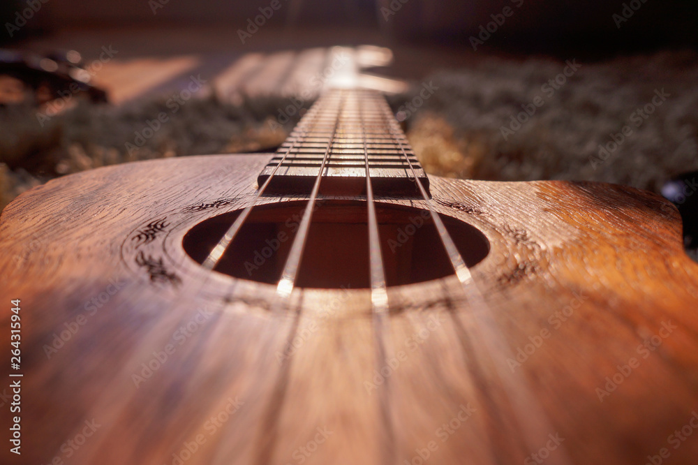 Down the strings. from the neck of a guitar looking down to the base of ...