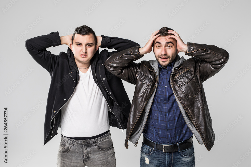 Two young upset men looking friend isolated over a white background ...